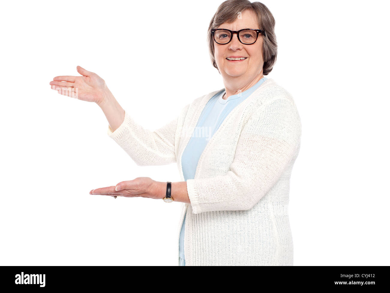 Smiling female presenting copy space against white background Stock ...