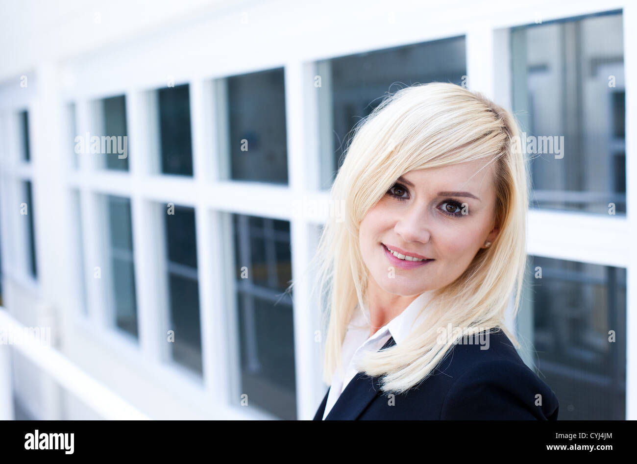 Attractive blonde woman with window Stock Photo - Alamy