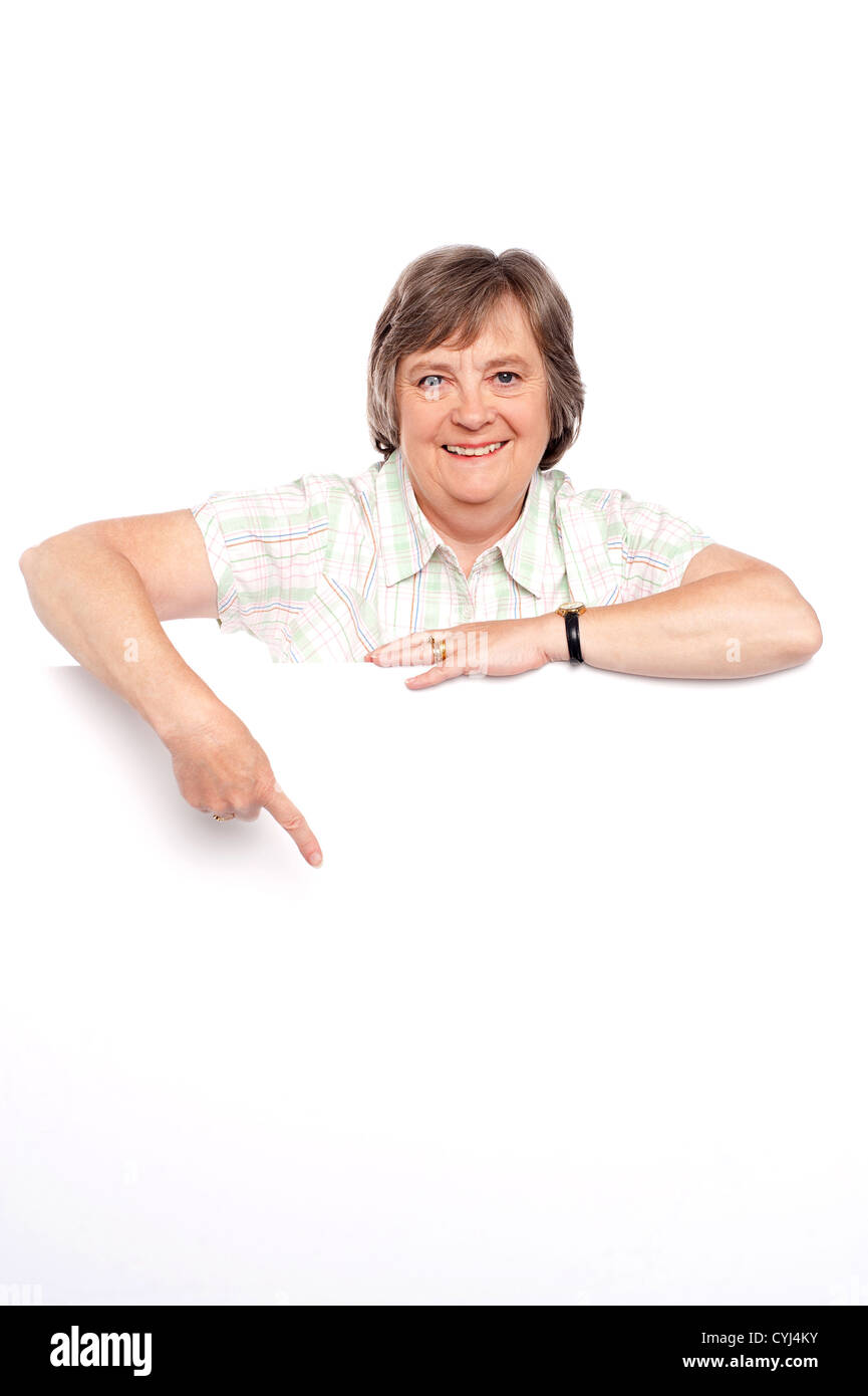 Beautiful old lady pointing at whiteboard with her finger Stock Photo ...