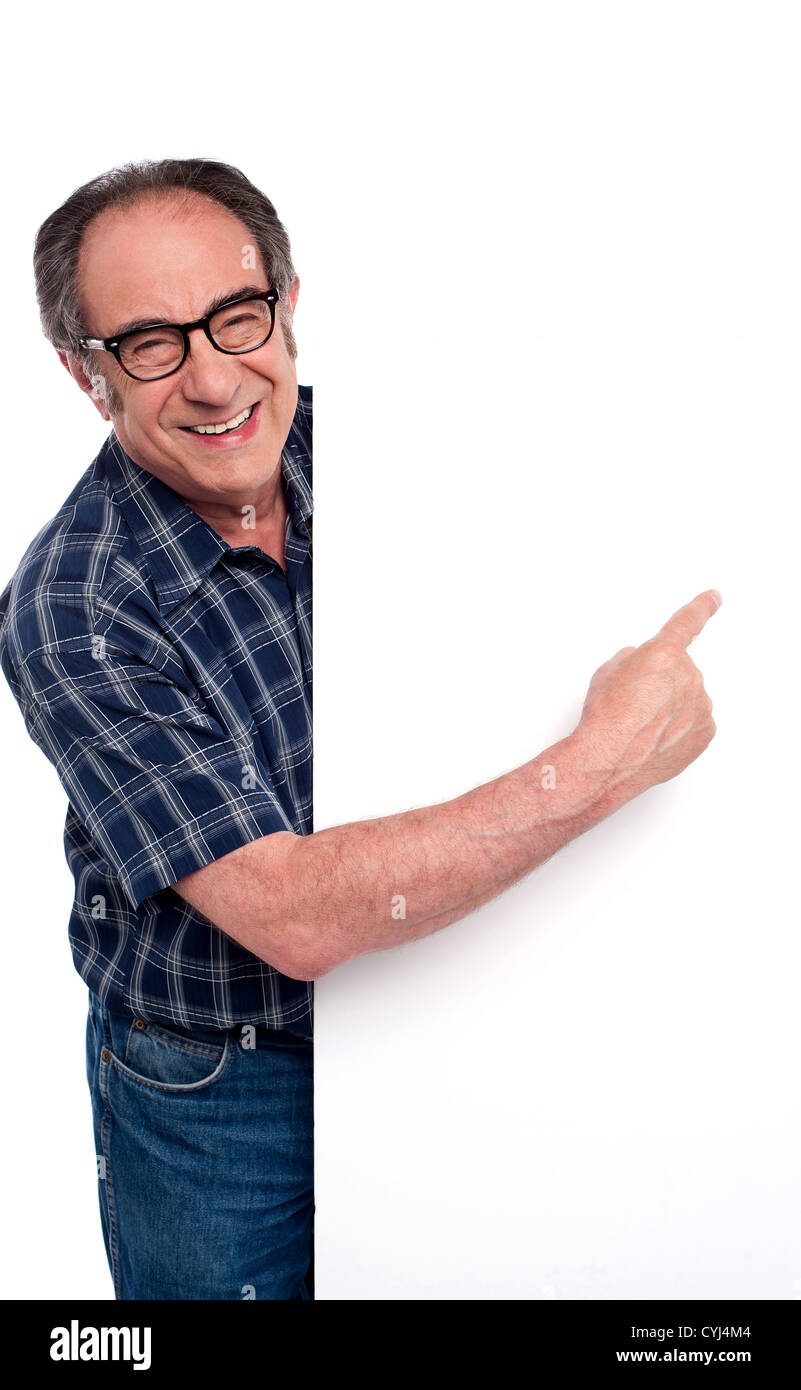 Causal matured man pointing finger at placard isolated over white ...