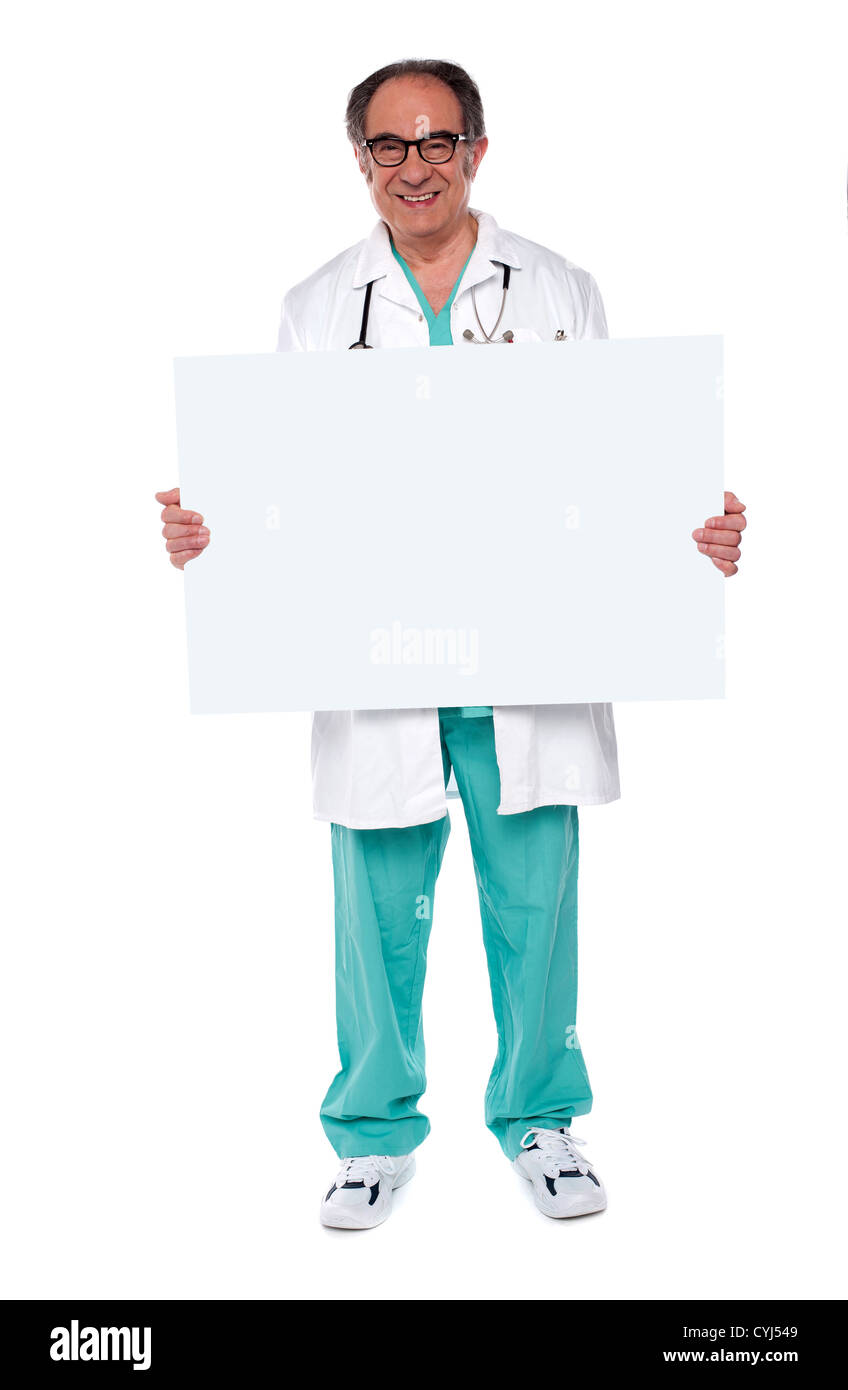 Confident smiling senior doctor showing blank whiteboard. Isolated ...