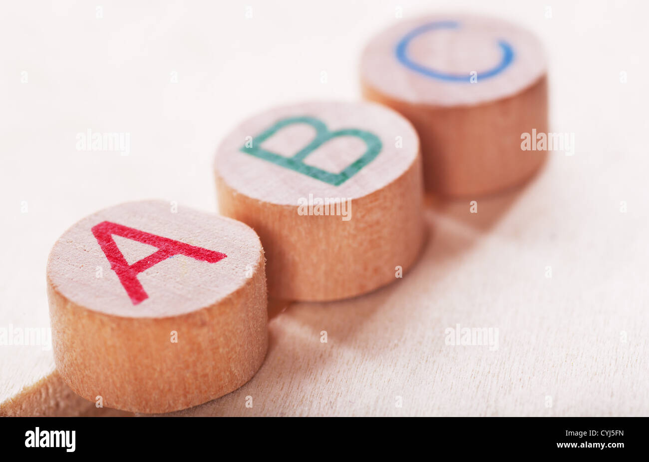 Three alphabet wooden blocks Stock Photo - Alamy