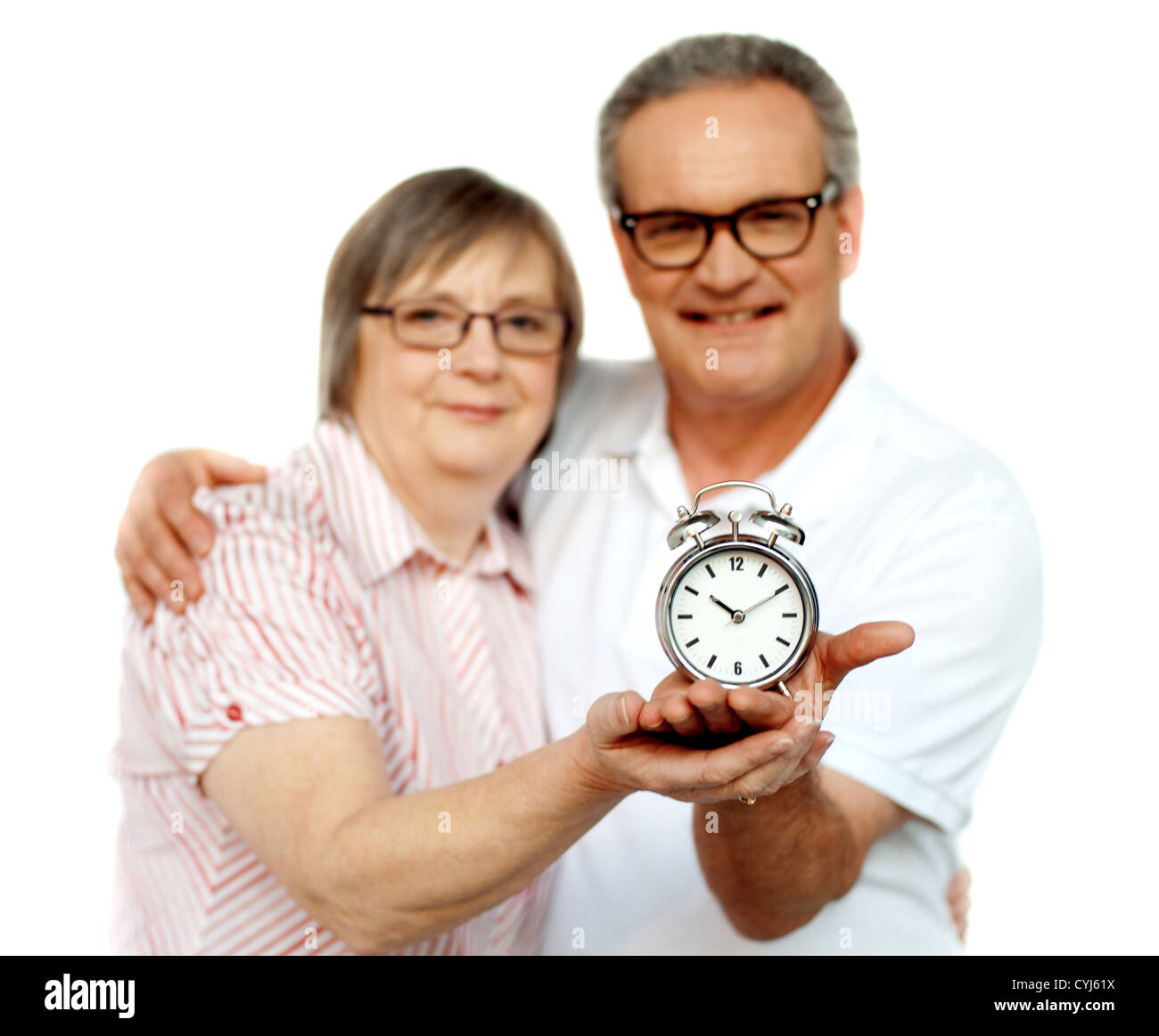 Aged couple with alarm clock on palm isolated over white Stock Photo ...