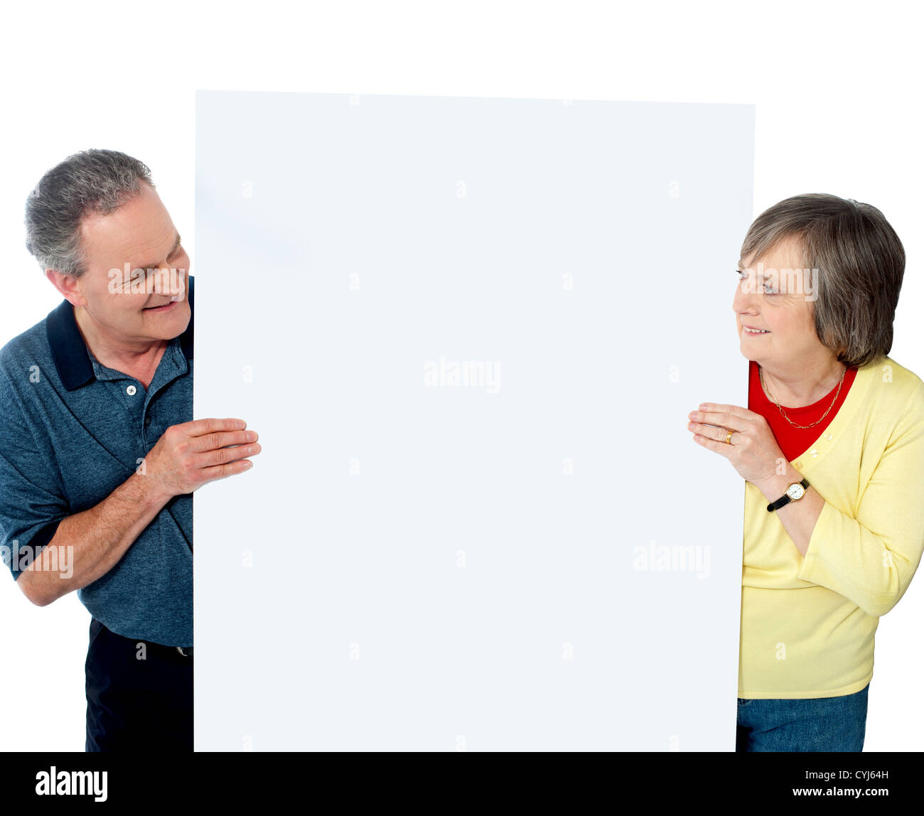 Old age couple presenting banner together against white background ...