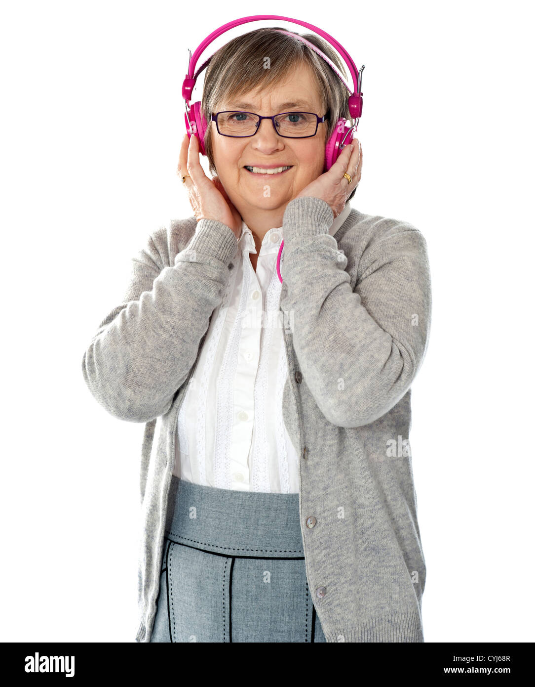 Attractive old lady wearing headphones listening music Stock Photo - Alamy