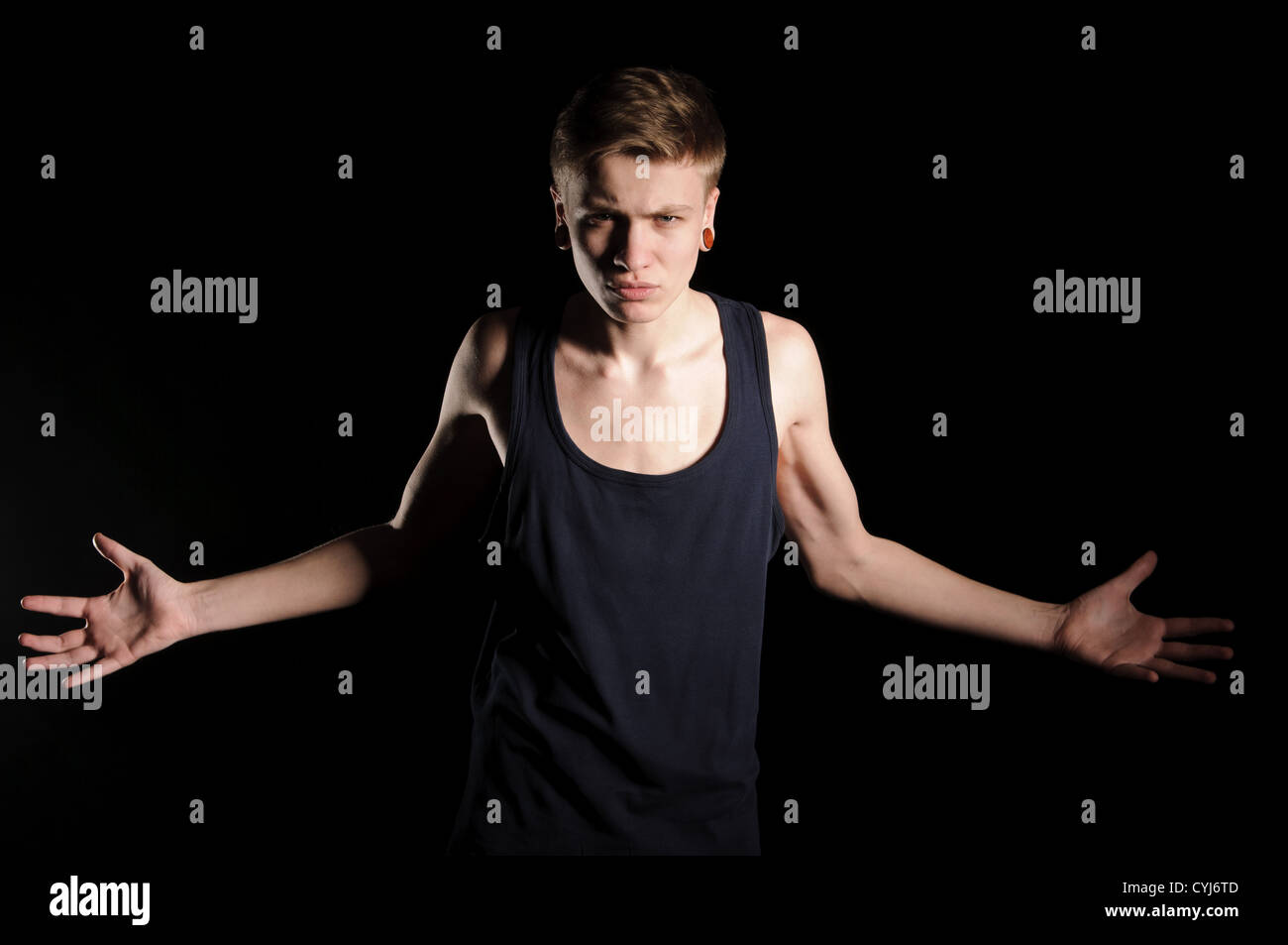 teenager showing muscles on the black background Stock Photo - Alamy