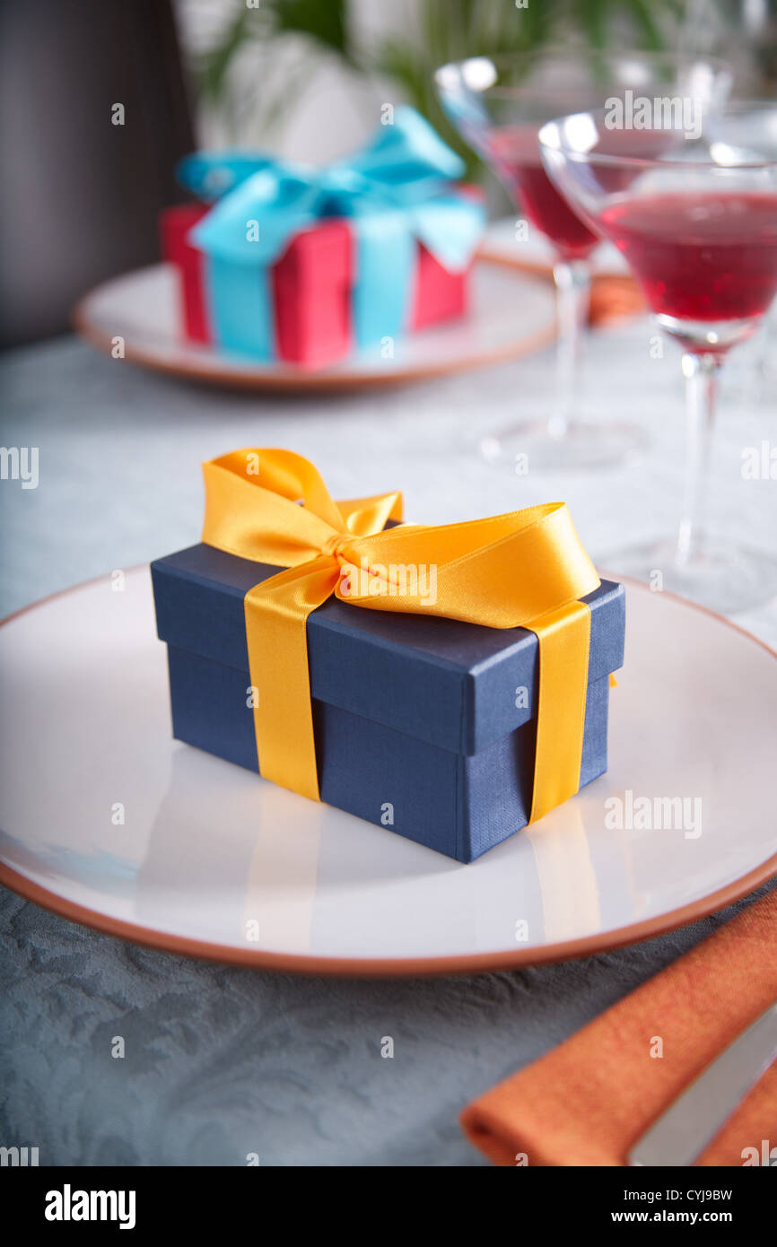 couple of gift boxes on white plates at restaurant Stock Photo - Alamy