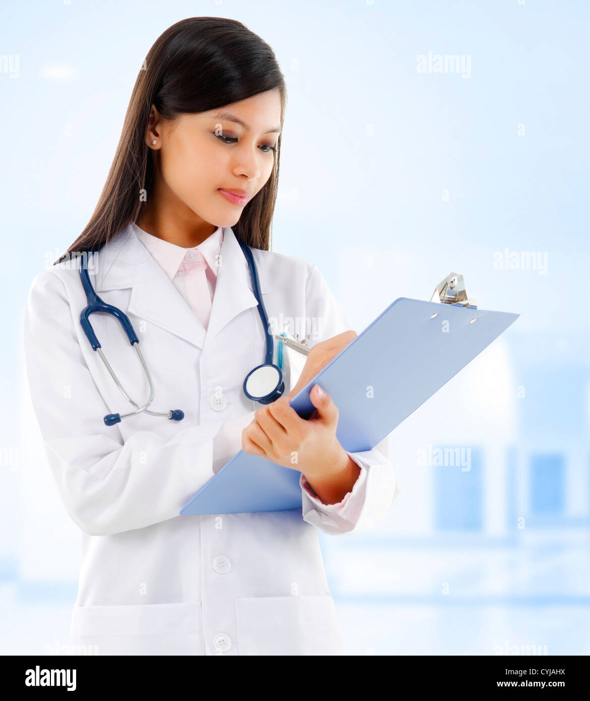 Young Asian female doctor writing medical report Stock Photo - Alamy