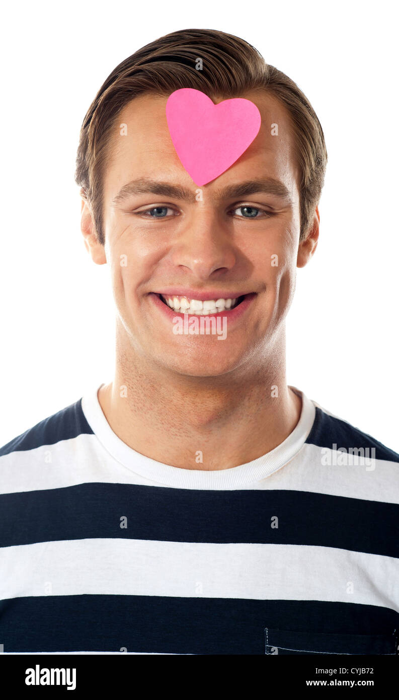 Attractive man posing with pink paper heart on his forehead Stock Photo ...