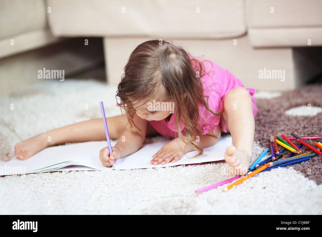 Child drawing alone at home Stock Photo - Alamy