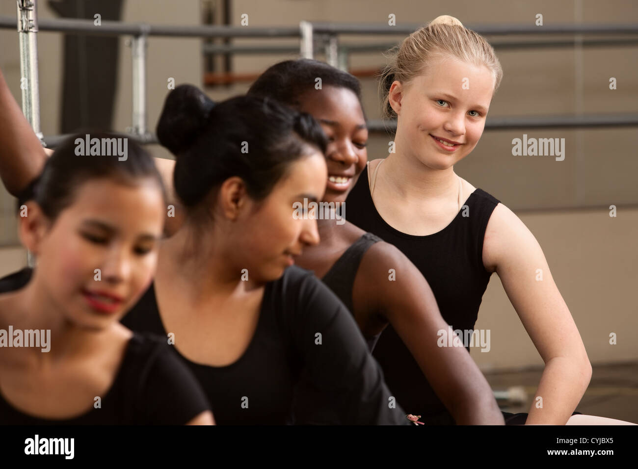 Smiling young ballet student with her classmates Stock Photo - Alamy