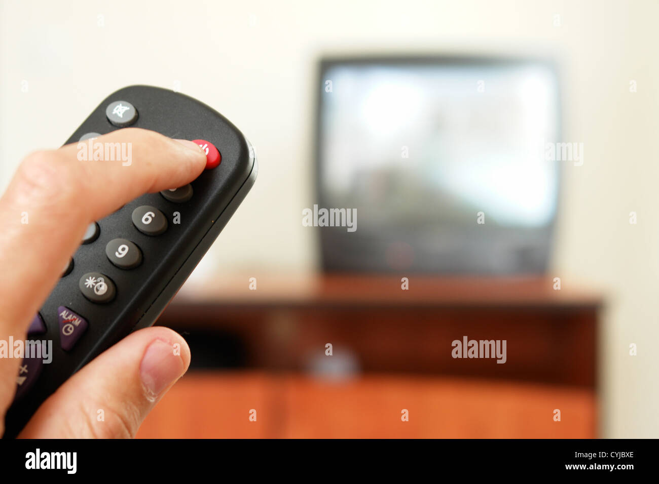 Television screen with tv remote control in foreground Stock Photo - Alamy