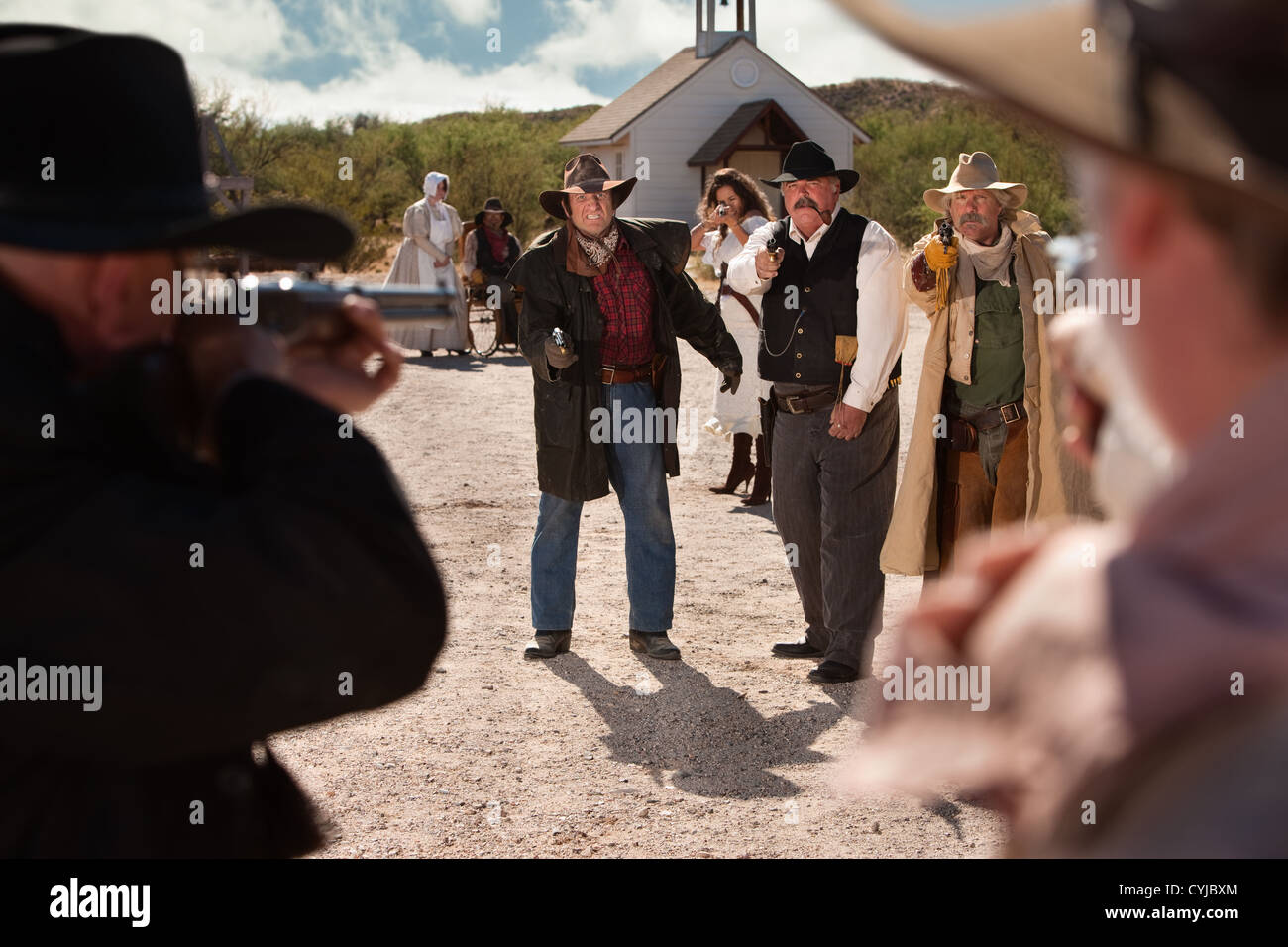 Cowboys pull out their weapons in an old west shoot out Stock Photo - Alamy