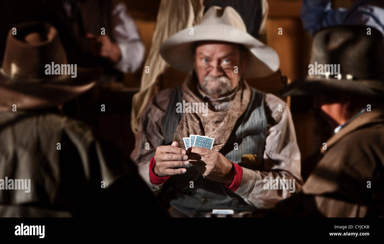 Bluffing card player in old American west saloon. Hands in focus Stock ...