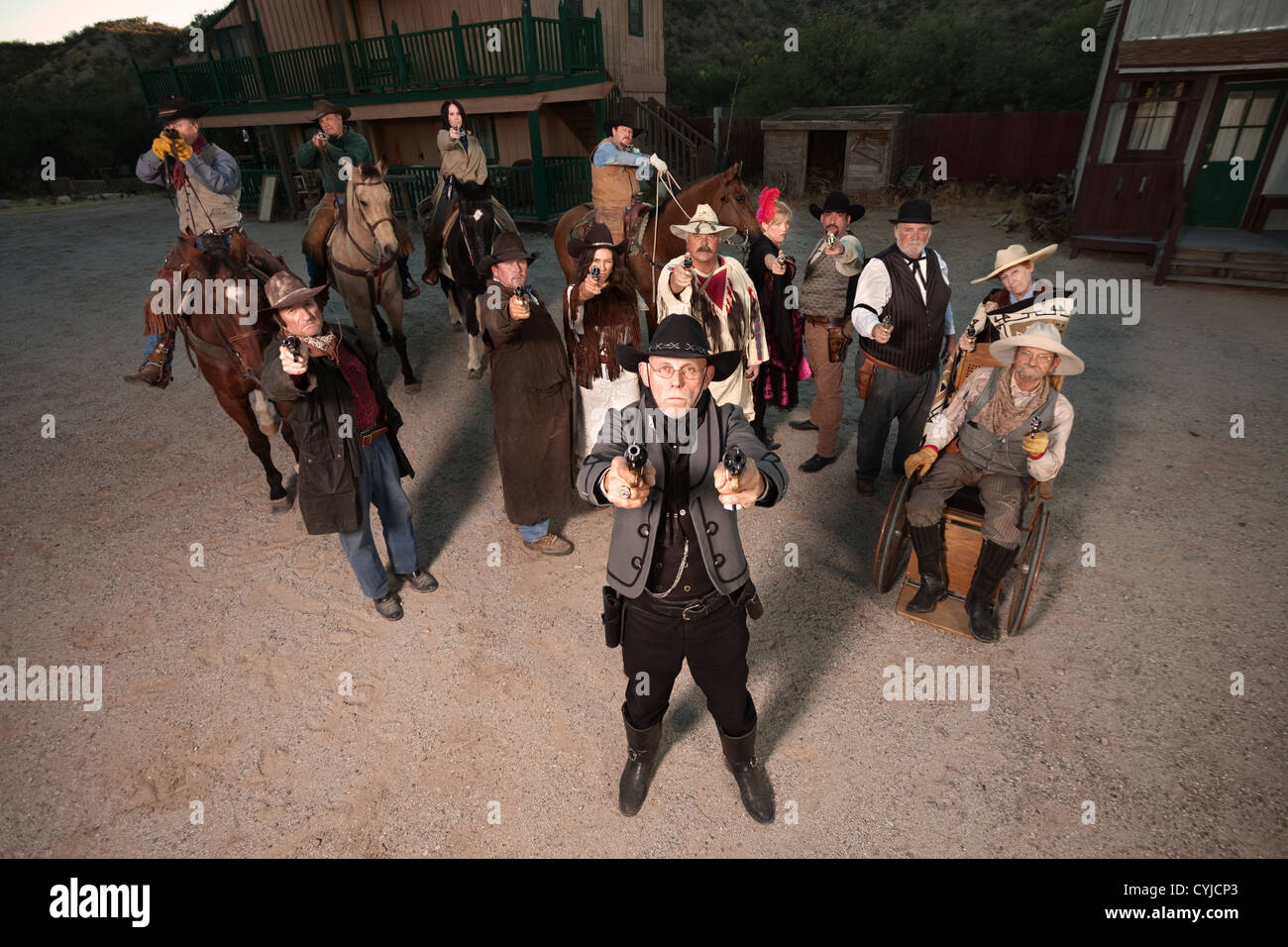 Man with two pistols backed up with a gang in old west costumes Stock ...