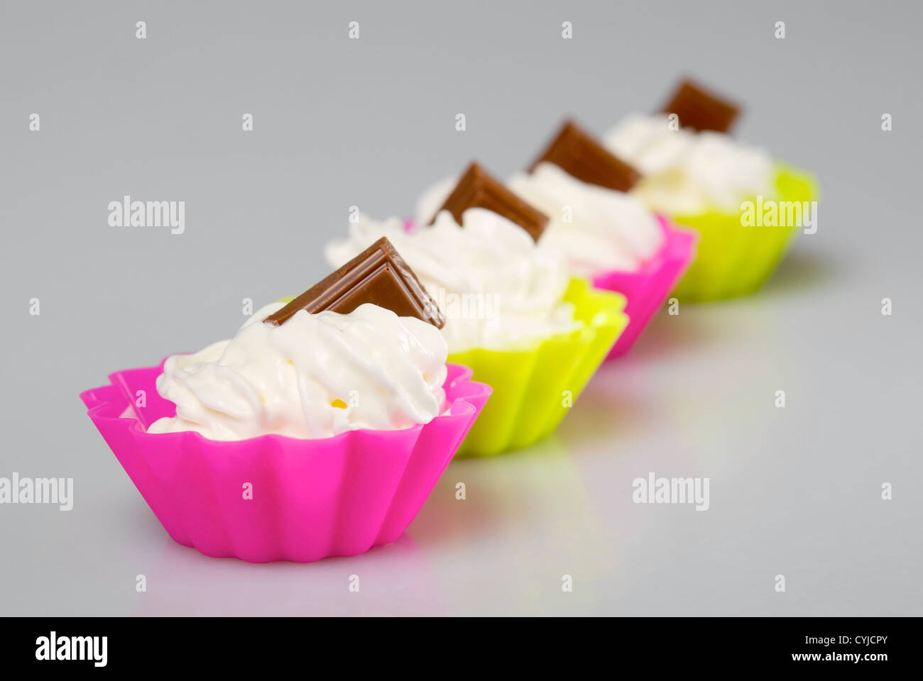 Four portions of whipped cream over white background Stock Photo - Alamy