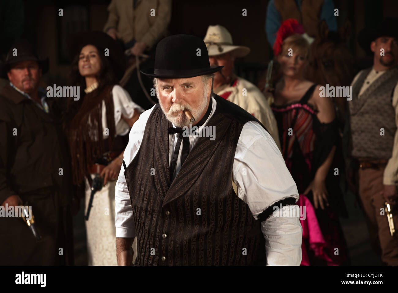 Mean looking man with cigar in old American west costume Stock Photo ...