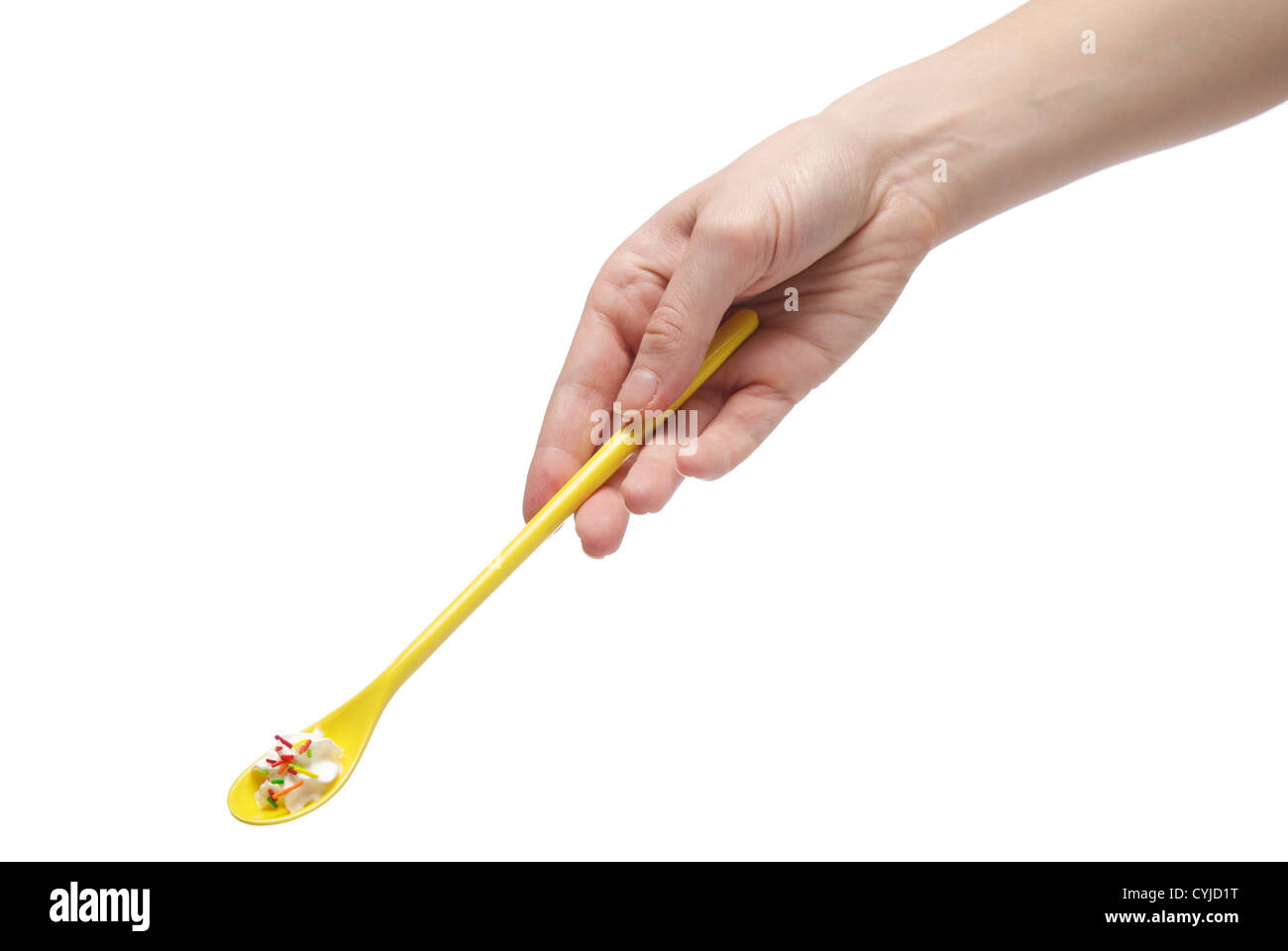 Hand holding a teaspoon full of cream, isolated on white background ...