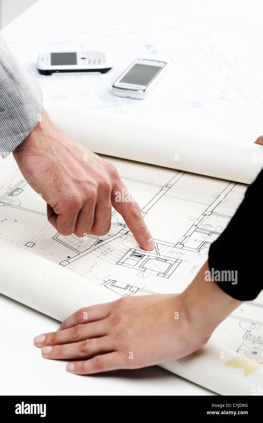 Architects hands pointing on the blueprint of new house project Stock ...