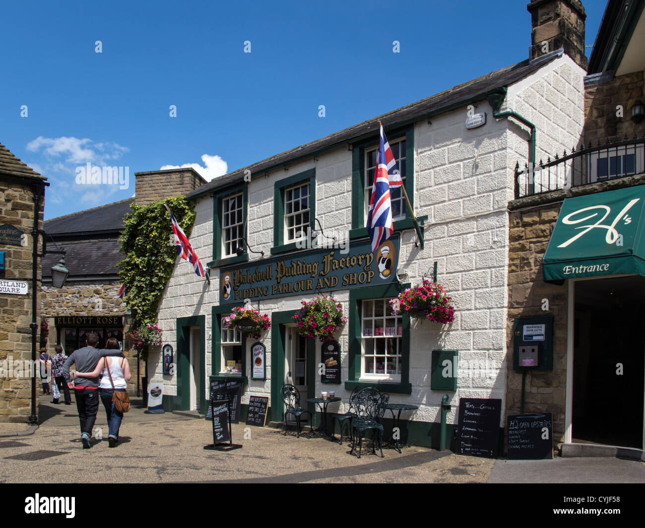 people shopping and walking around the Derbyshire village of Bakewell ...