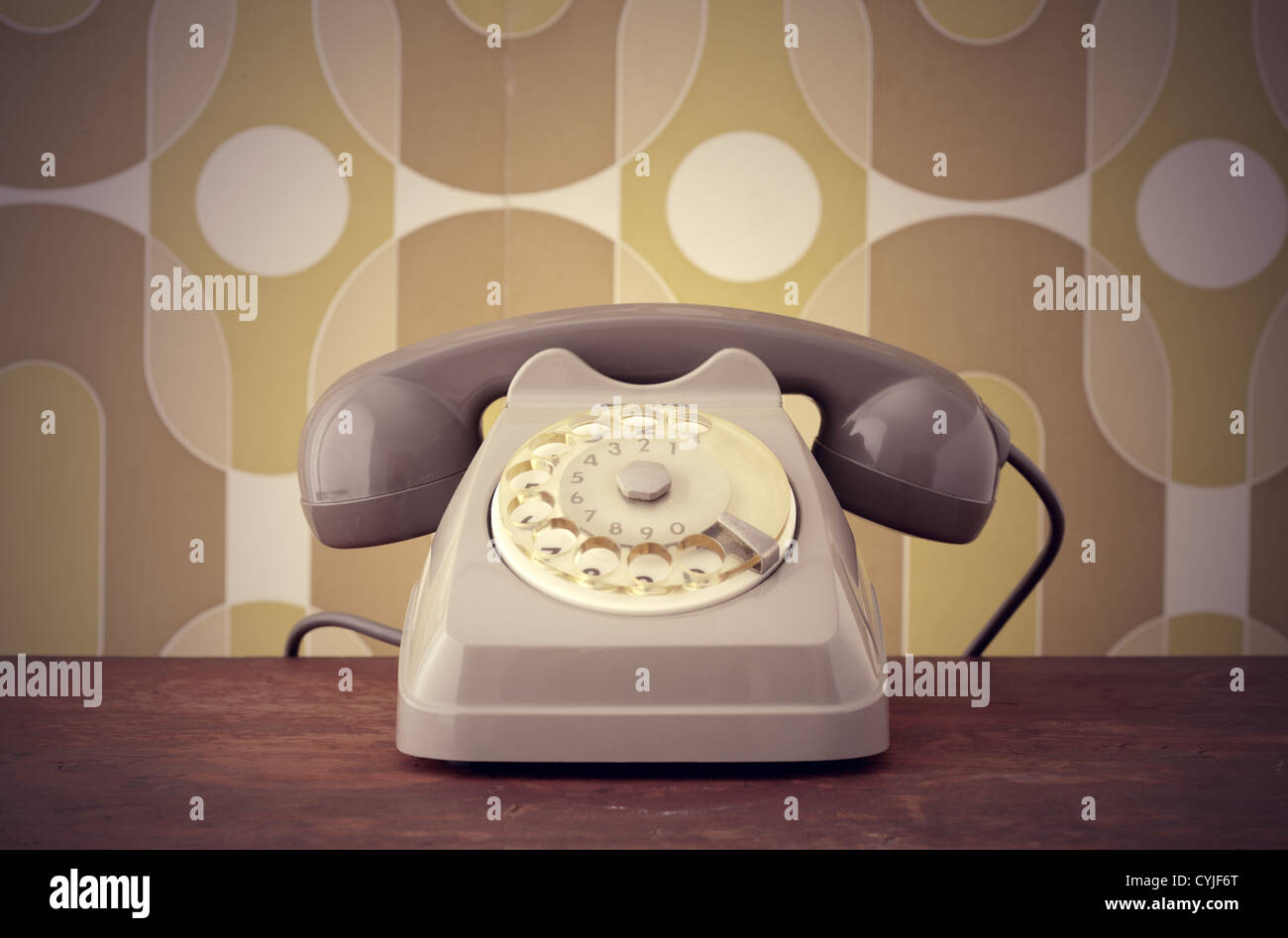 Old-fashioned phone on vintage background Stock Photo - Alamy