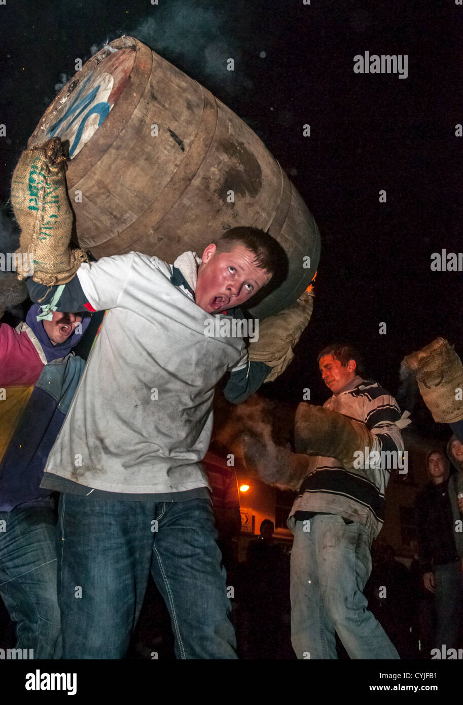 Young barrel rollers run through the crowd and the streets of Ottery St ...