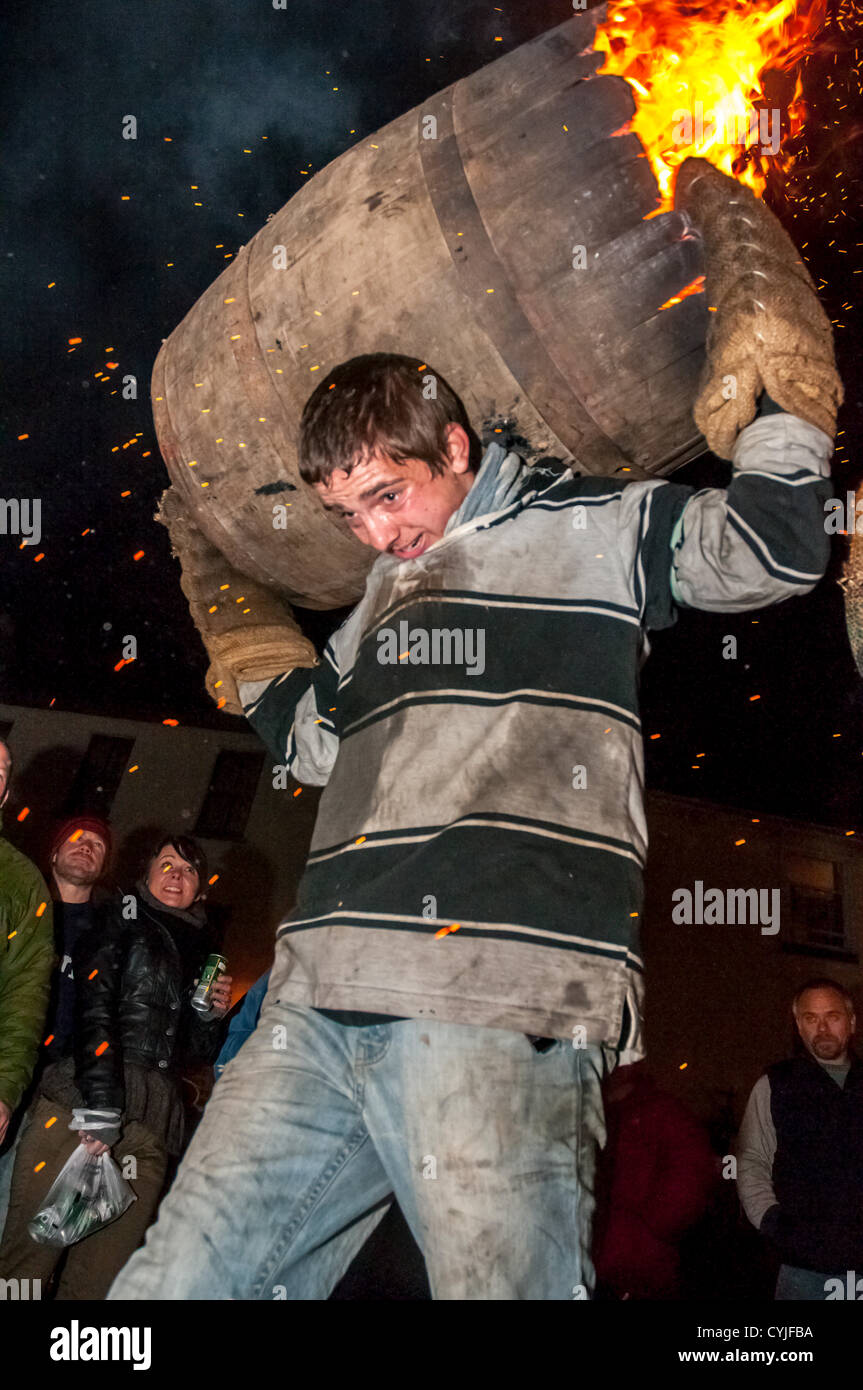 Young barrel rollers run through the crowd and the streets of Ottery St ...