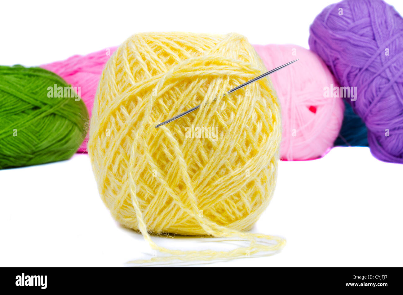 Thread balls and needle Stock Photo - Alamy