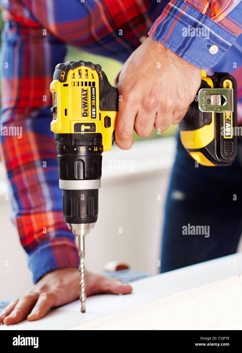 Man holding drill Stock Photo - Alamy