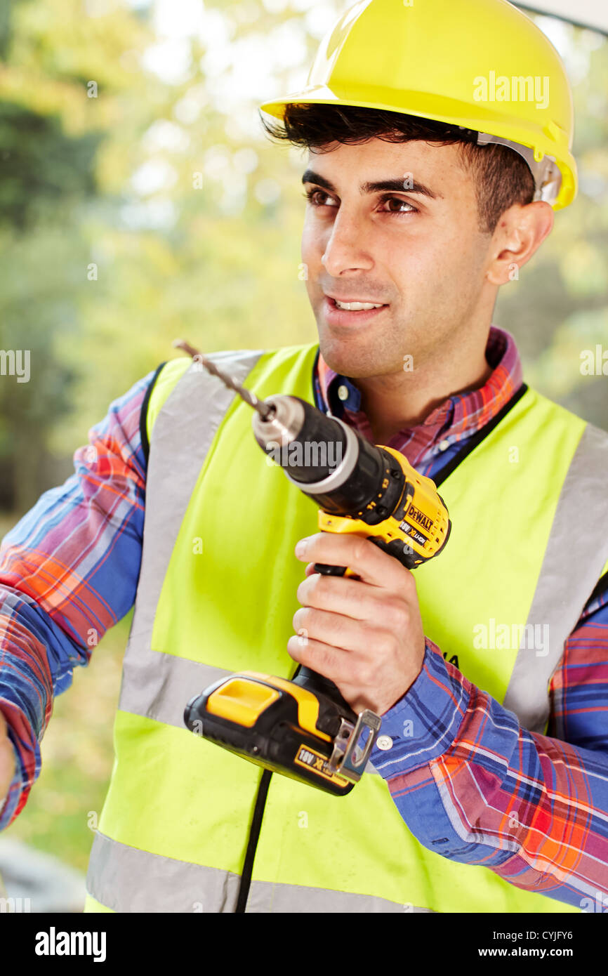Man holding drill Stock Photo - Alamy