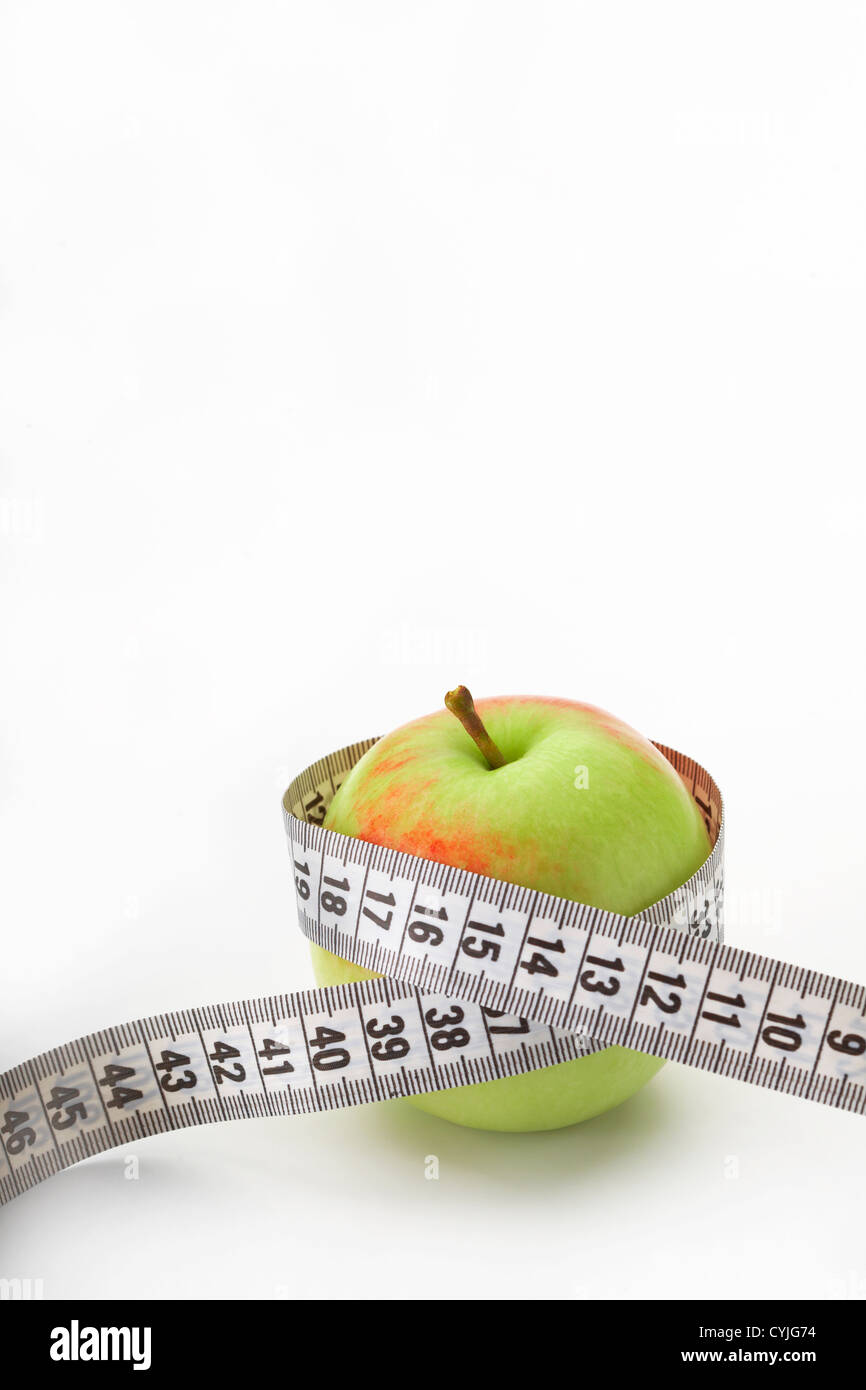 Apple with a measuring tape on white Stock Photo - Alamy