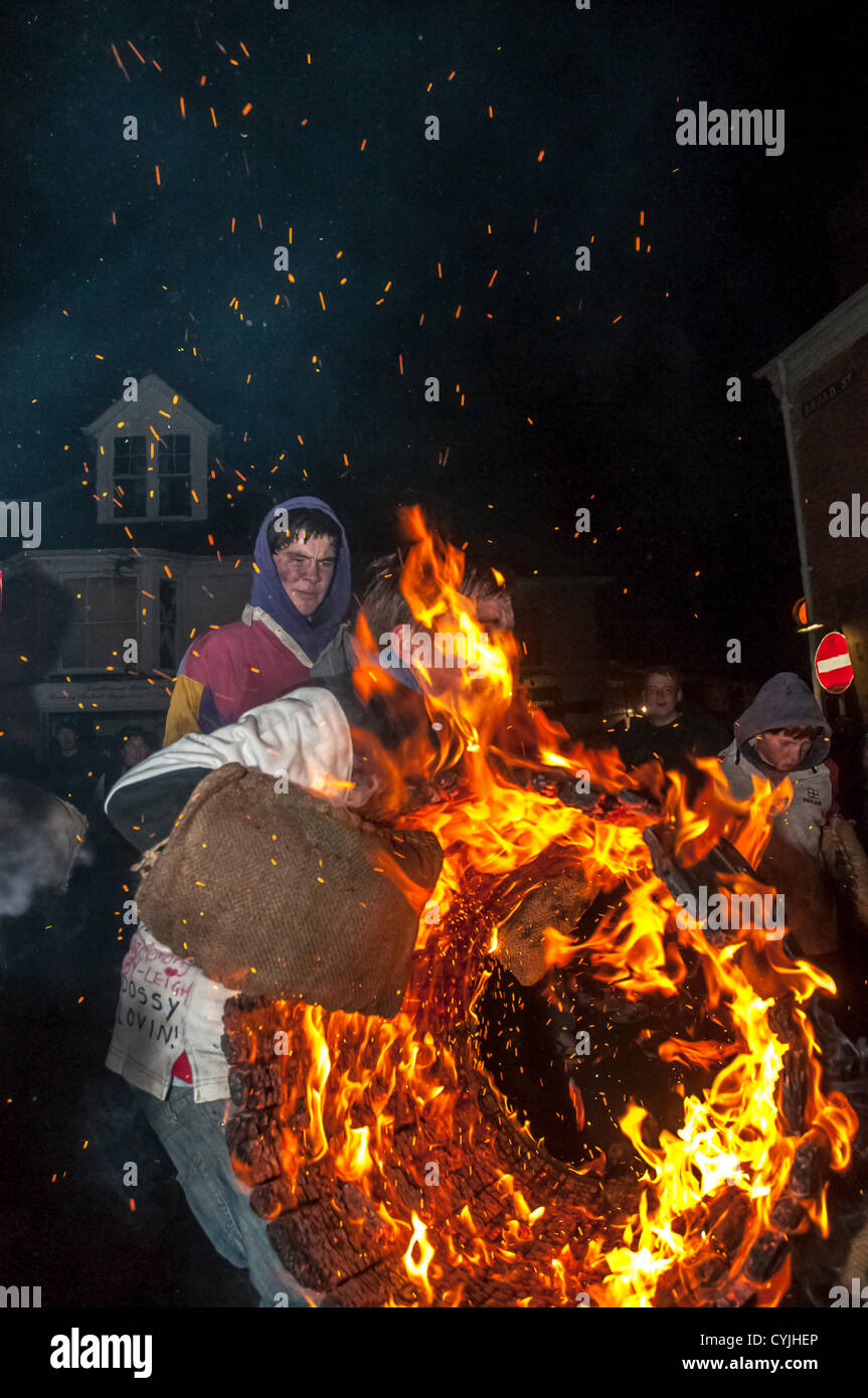 Young barrel roller picks up a flaming tar barrel during the 2012 Tar ...