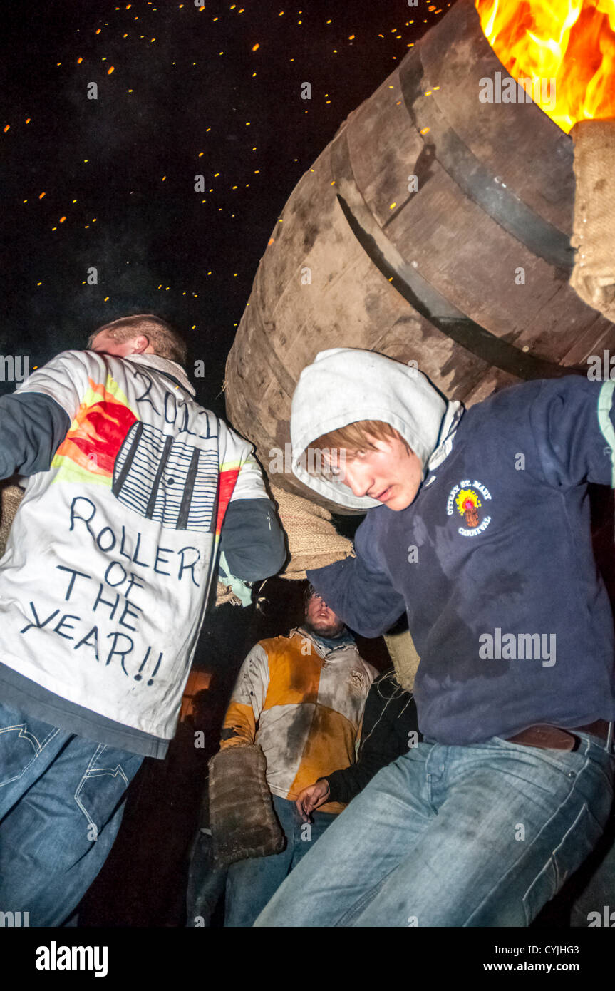 Barrel rollers run through the crowd and the streets of Ottery St Mary ...