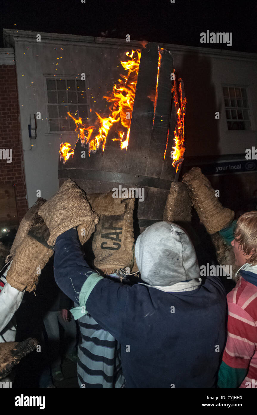 Barrel rollers run through the crowd and the streets of Ottery St Mary ...