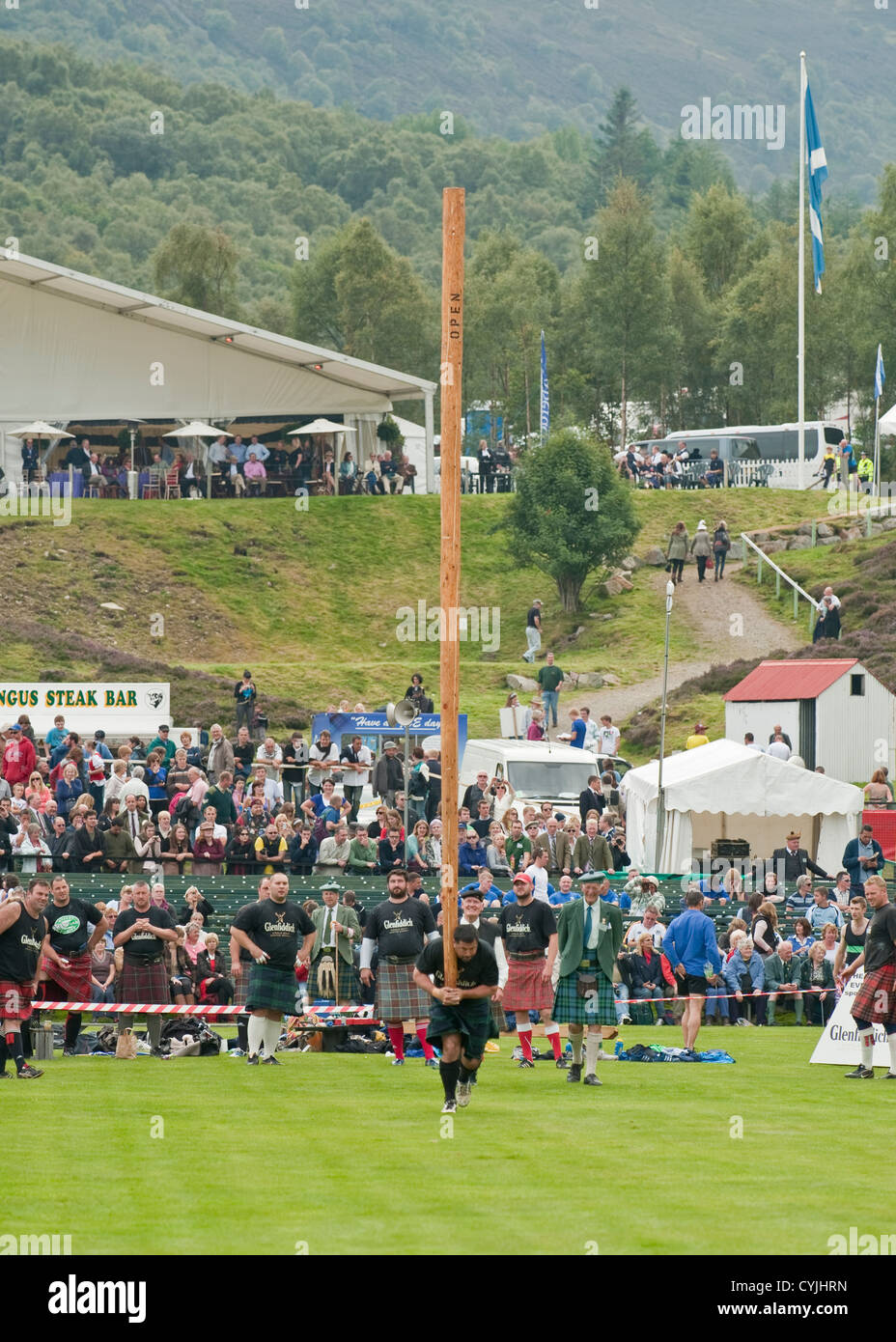 Man competing in a "Toss the Caber" competition at the Royal Highland ...