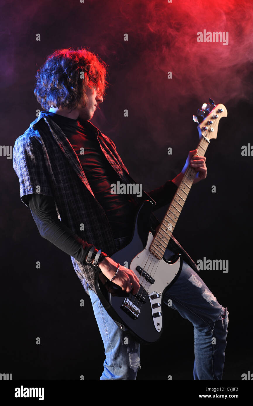 a bassist plays at a live concert Stock Photo - Alamy