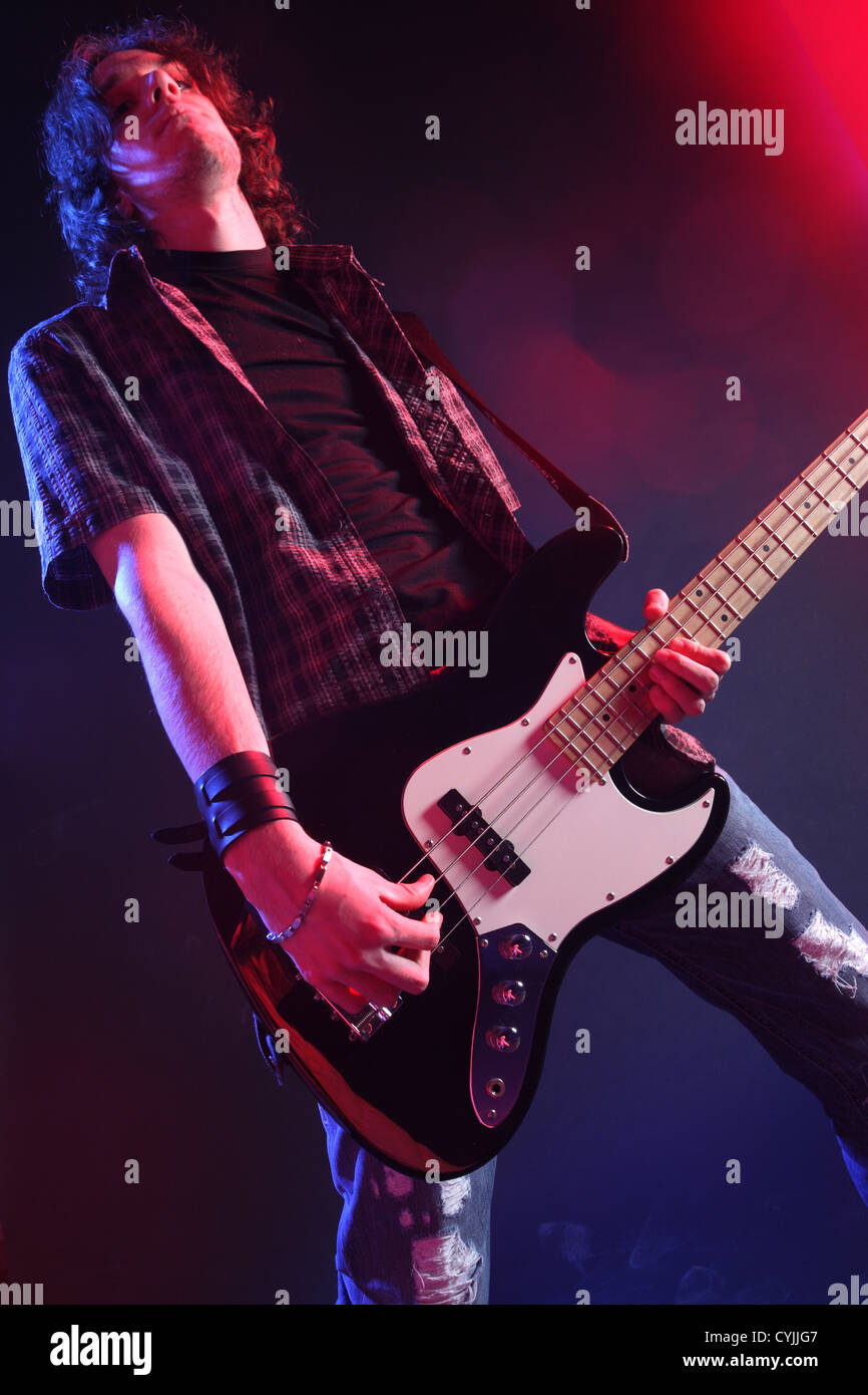 a bassist plays at a live concert Stock Photo - Alamy