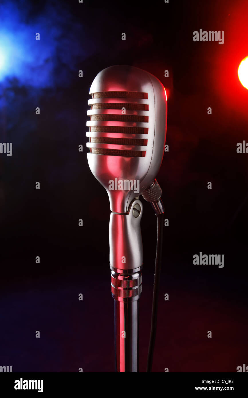 old microphone on a dark background and smoky Stock Photo - Alamy