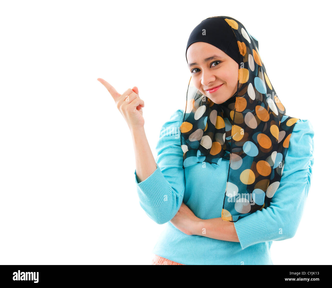 Cute young Muslim woman pointing on empty space, isolated on white ...