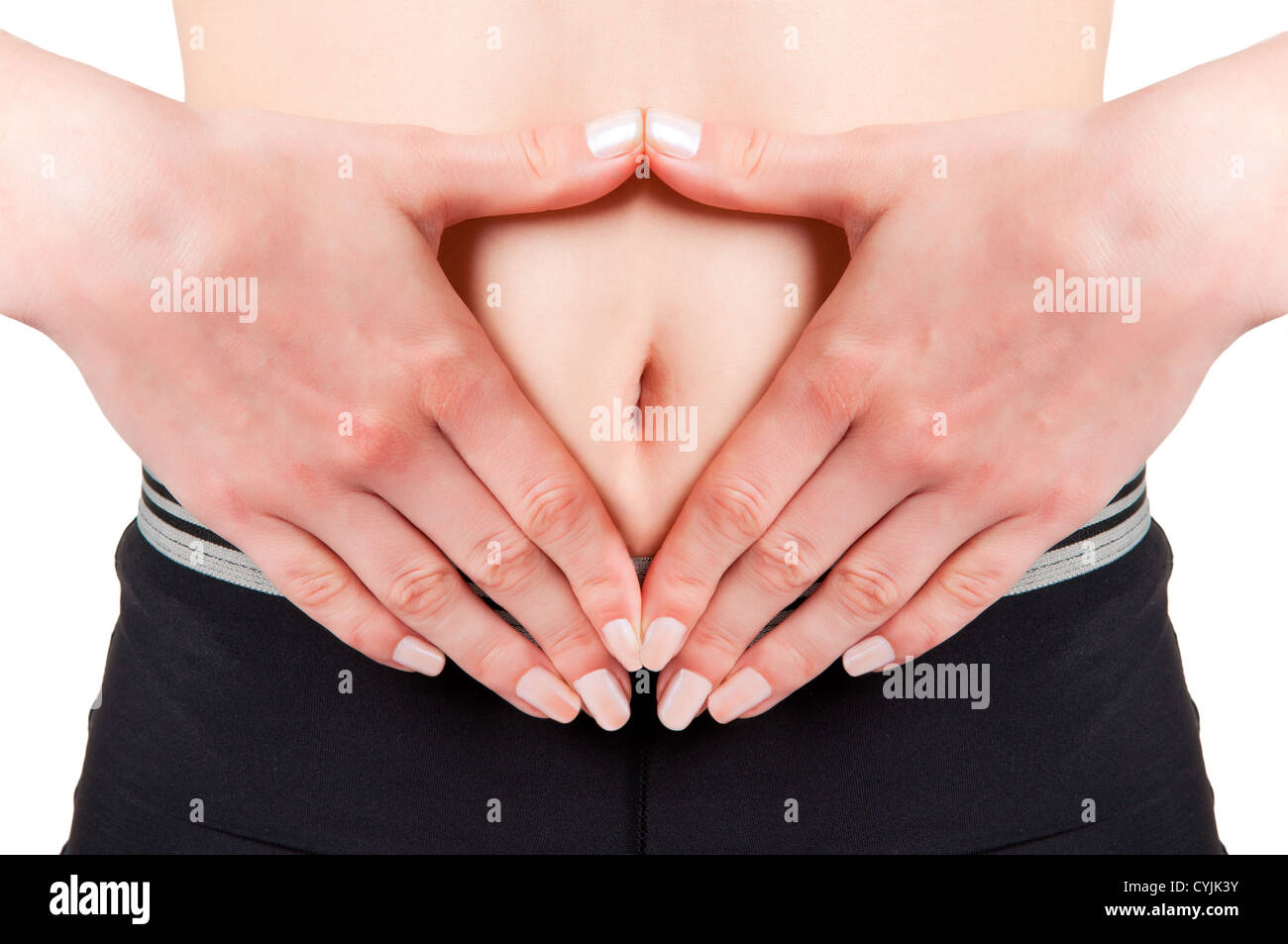 Woman with her hands around her belly button Stock Photo - Alamy