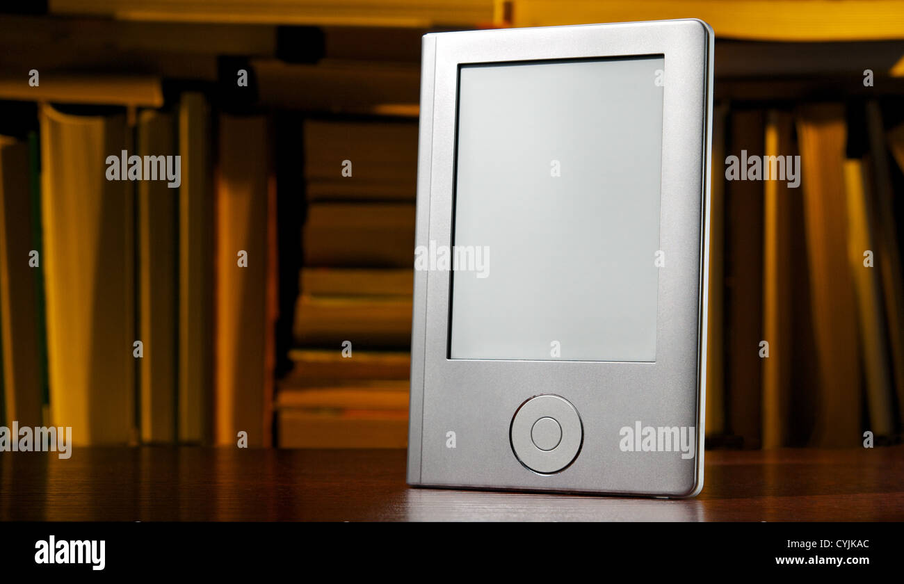 Electronic reader and an old books on the background Stock Photo - Alamy