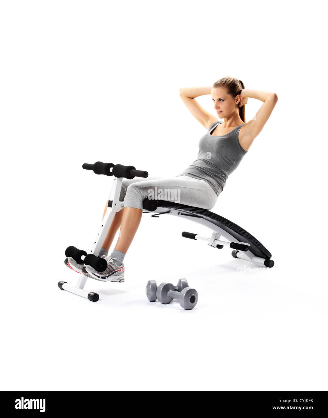 beautiful young Woman exercising abdomen muscles on bench Stock Photo ...