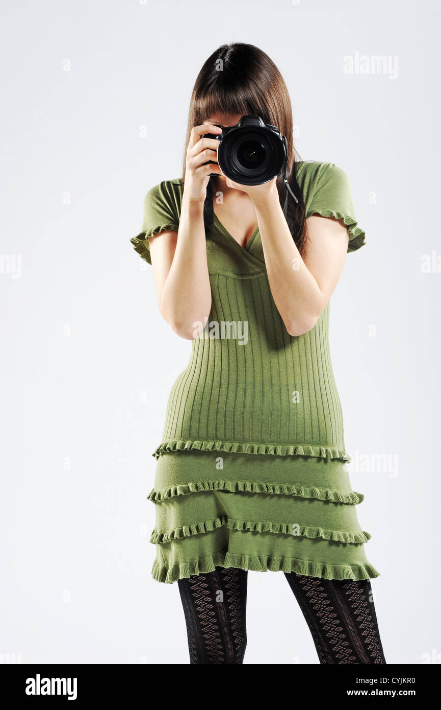 young woman looking through slr camera Stock Photo - Alamy
