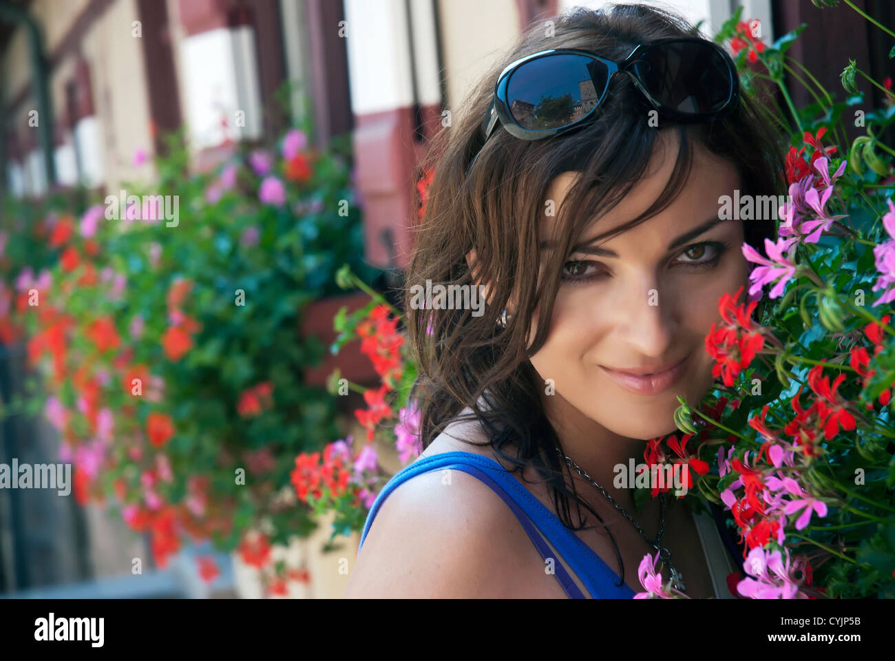Beautiful woman by window with flowers Stock Photo - Alamy