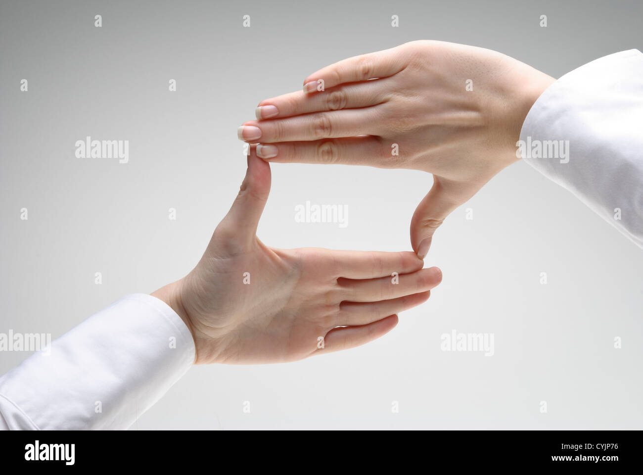 Woman's hand showing crop symbol over light background Stock Photo - Alamy