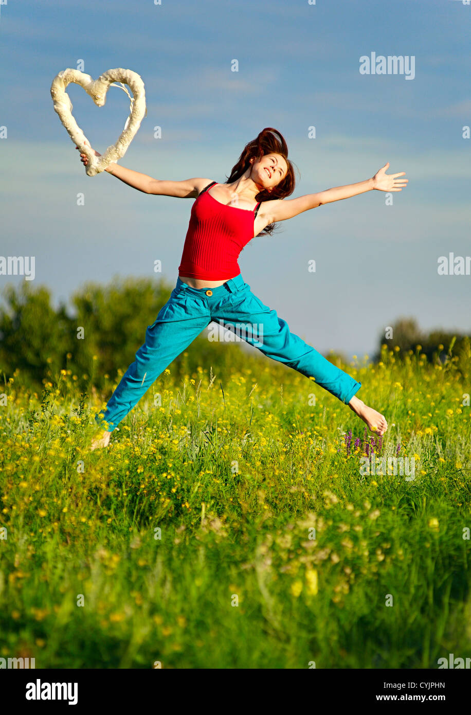 Woman running on a sunset field Stock Photo - Alamy