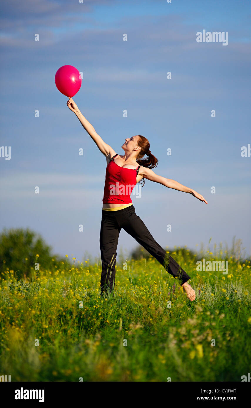 Woman jumping with a red balloon Stock Photo - Alamy