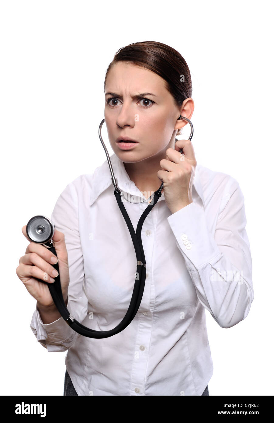Frightened female doctor listen with a stethoscope isolated on white ...