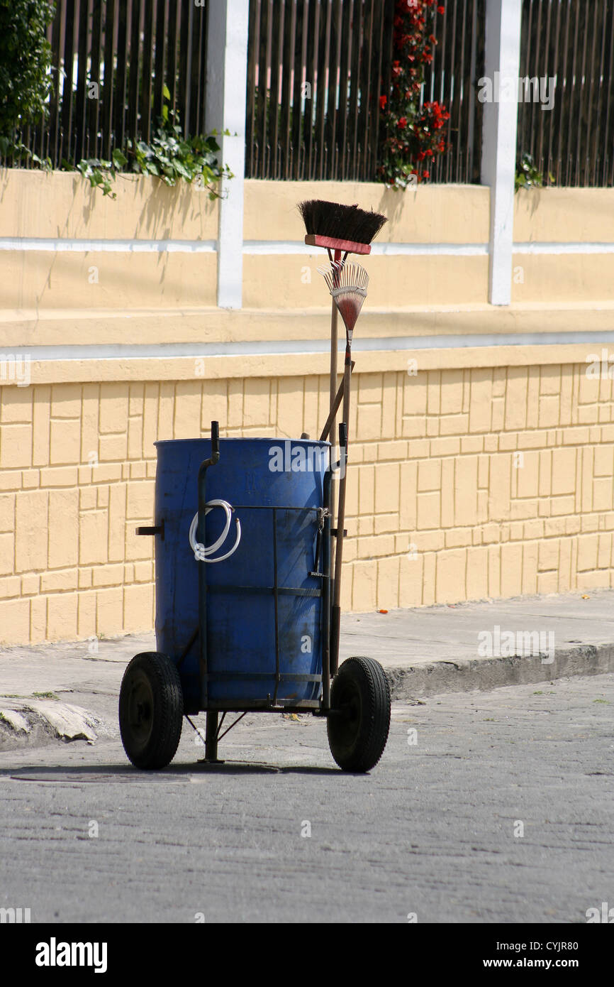 A garbage bin and equipment used by street cleaners with the sanitation ...