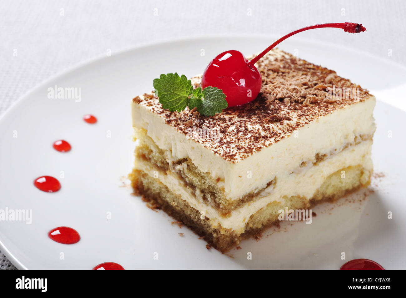 Tiramisu - Classical Dessert with Coffee on white plate. Garnished with ...